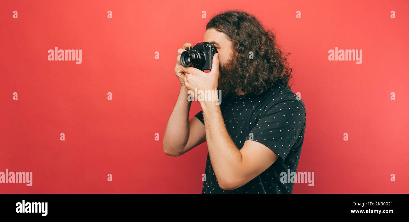 Side view photo of bearded hispter man with long hair making a photo ...