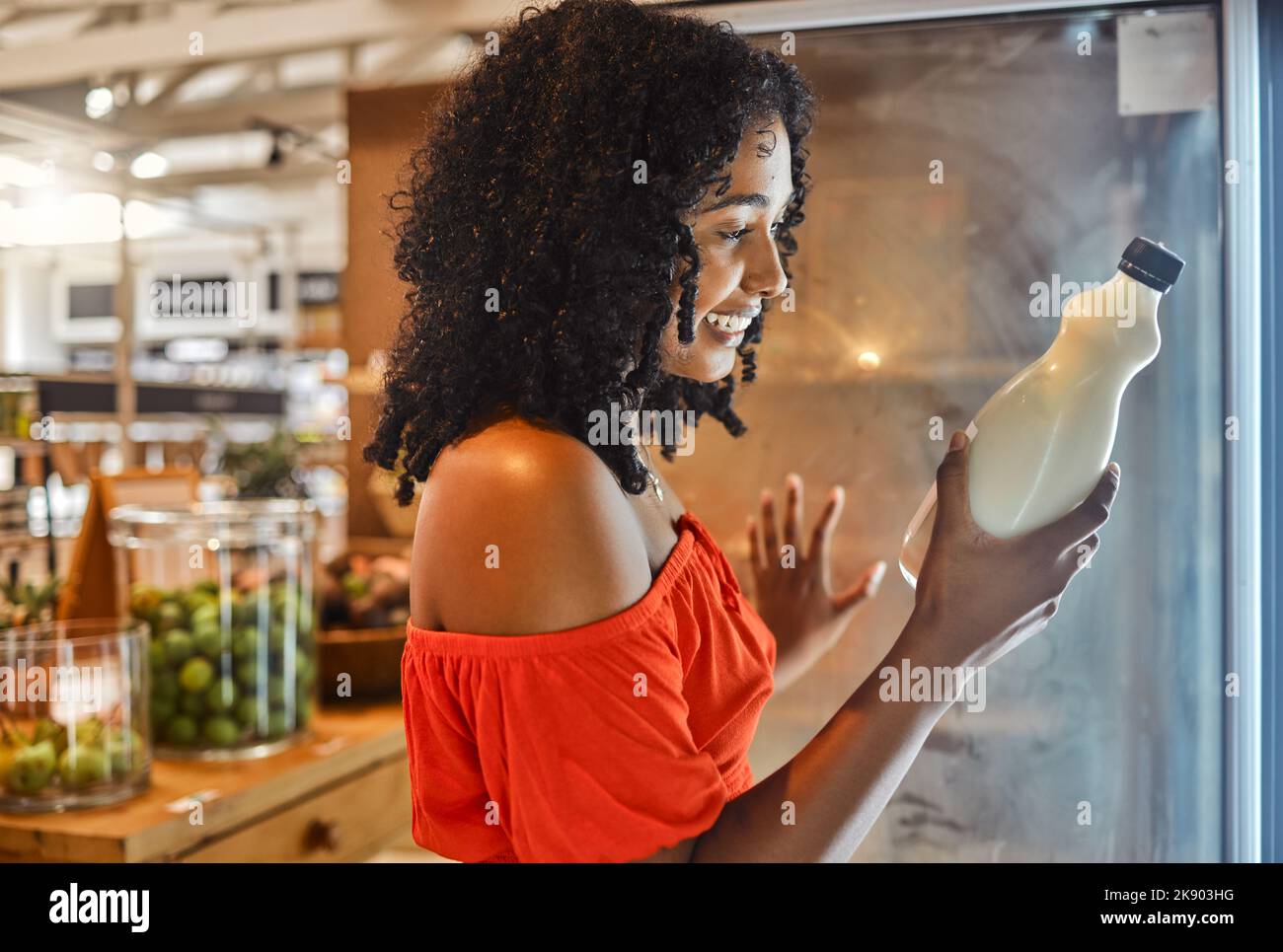 Woman, grocery shopping or reading milk label for sales date, vitamin ...