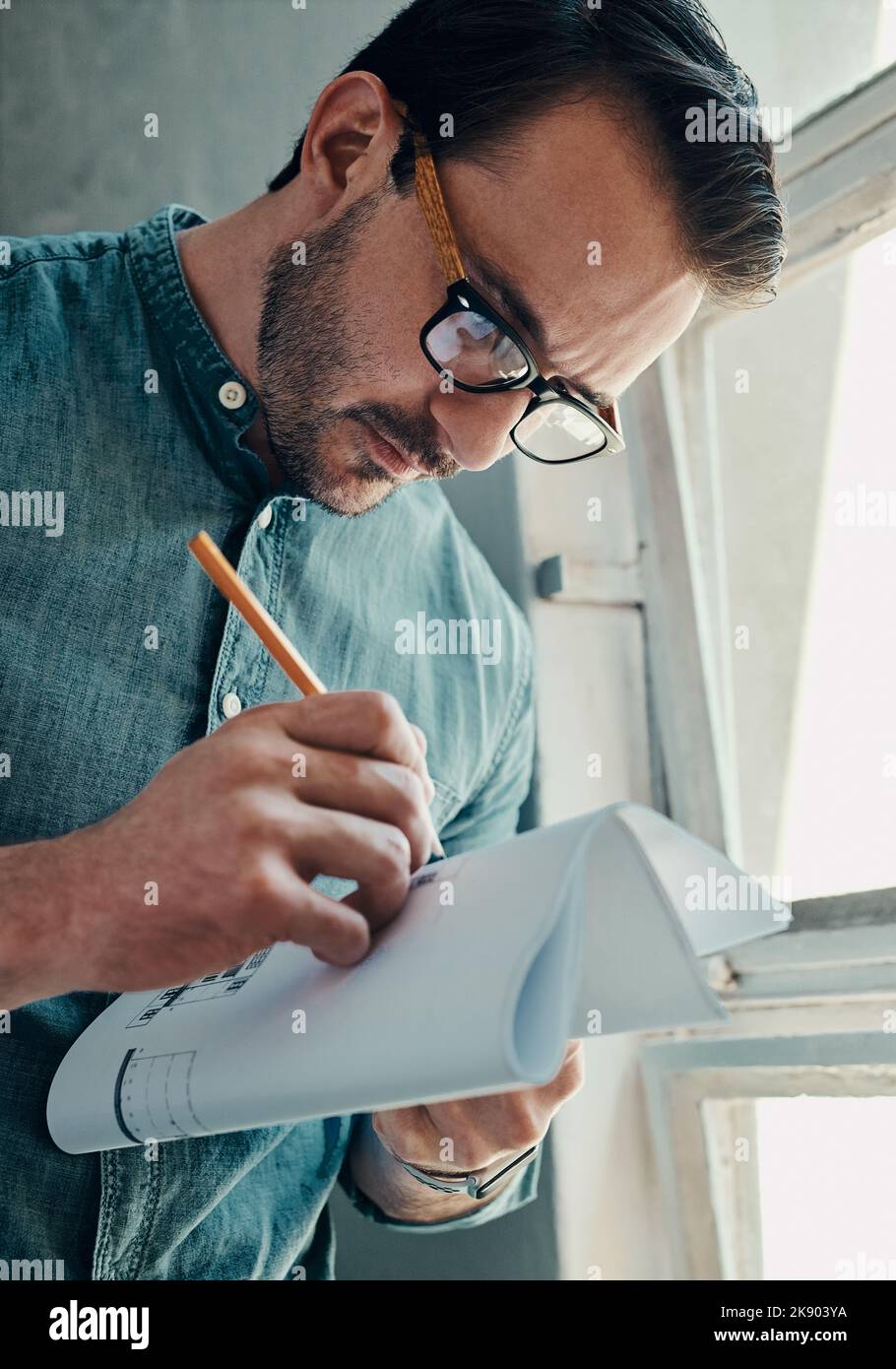 Designer holding blueprint writing on hi-res stock photography and ...