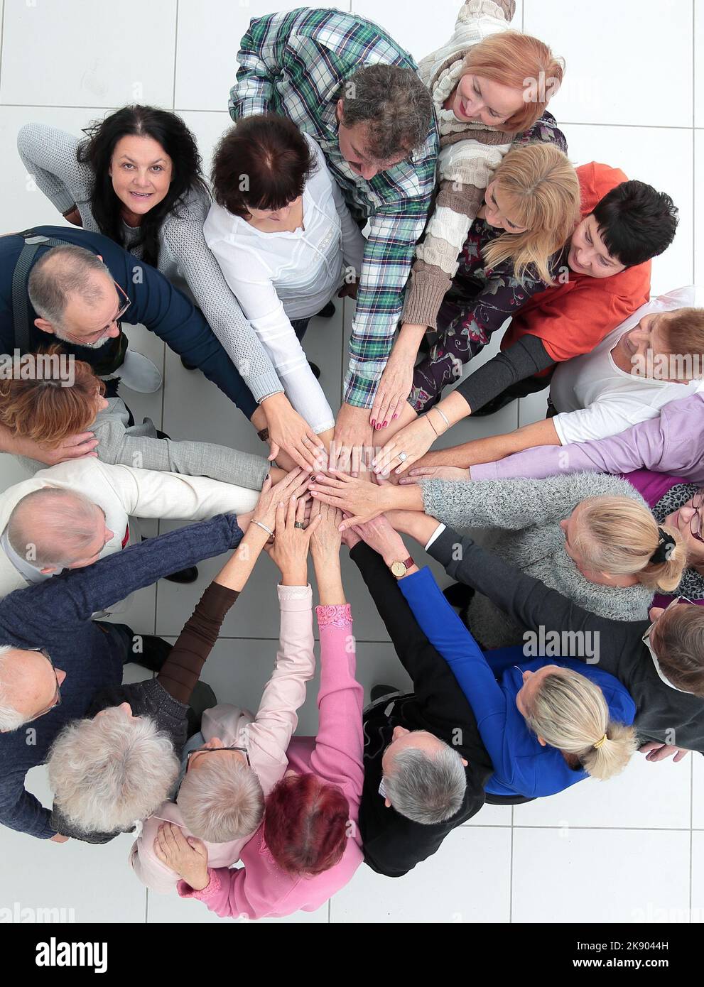 group of older people joining their palms together Stock Photo - Alamy