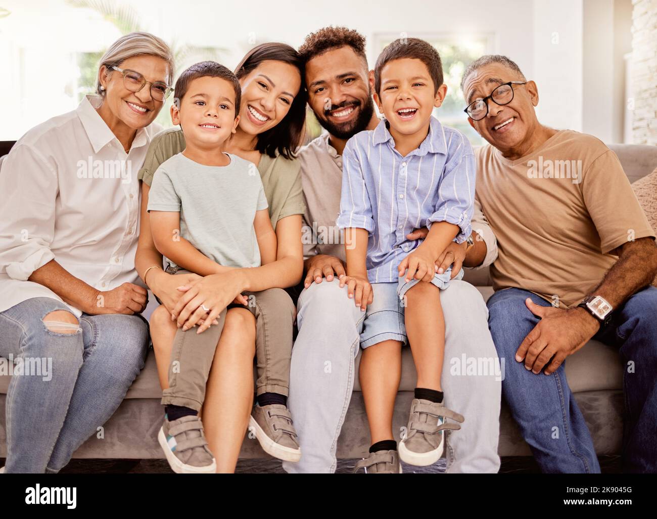 Happy, big family and smile on home living room sofa spending quality ...
