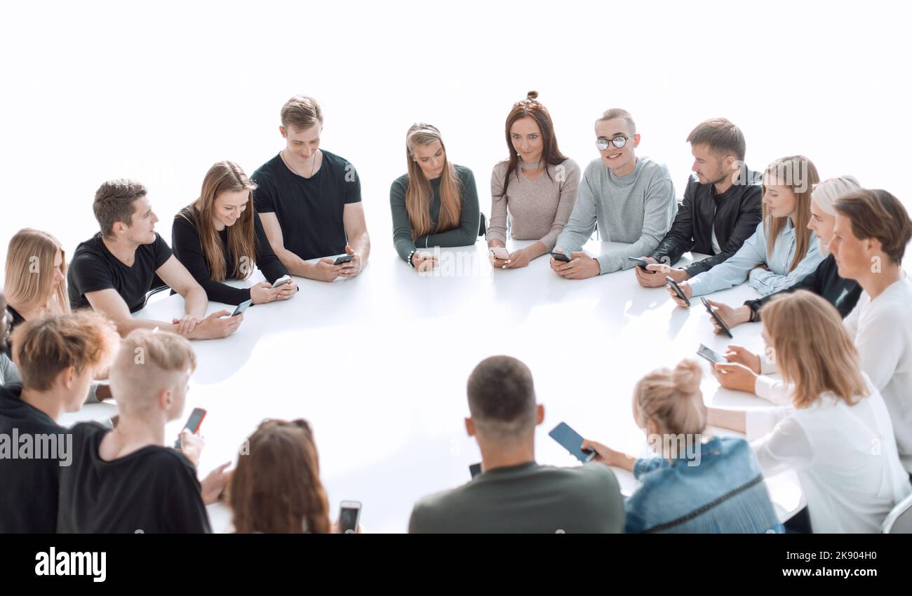 study group of young people sitting at a round table Stock Photo - Alamy
