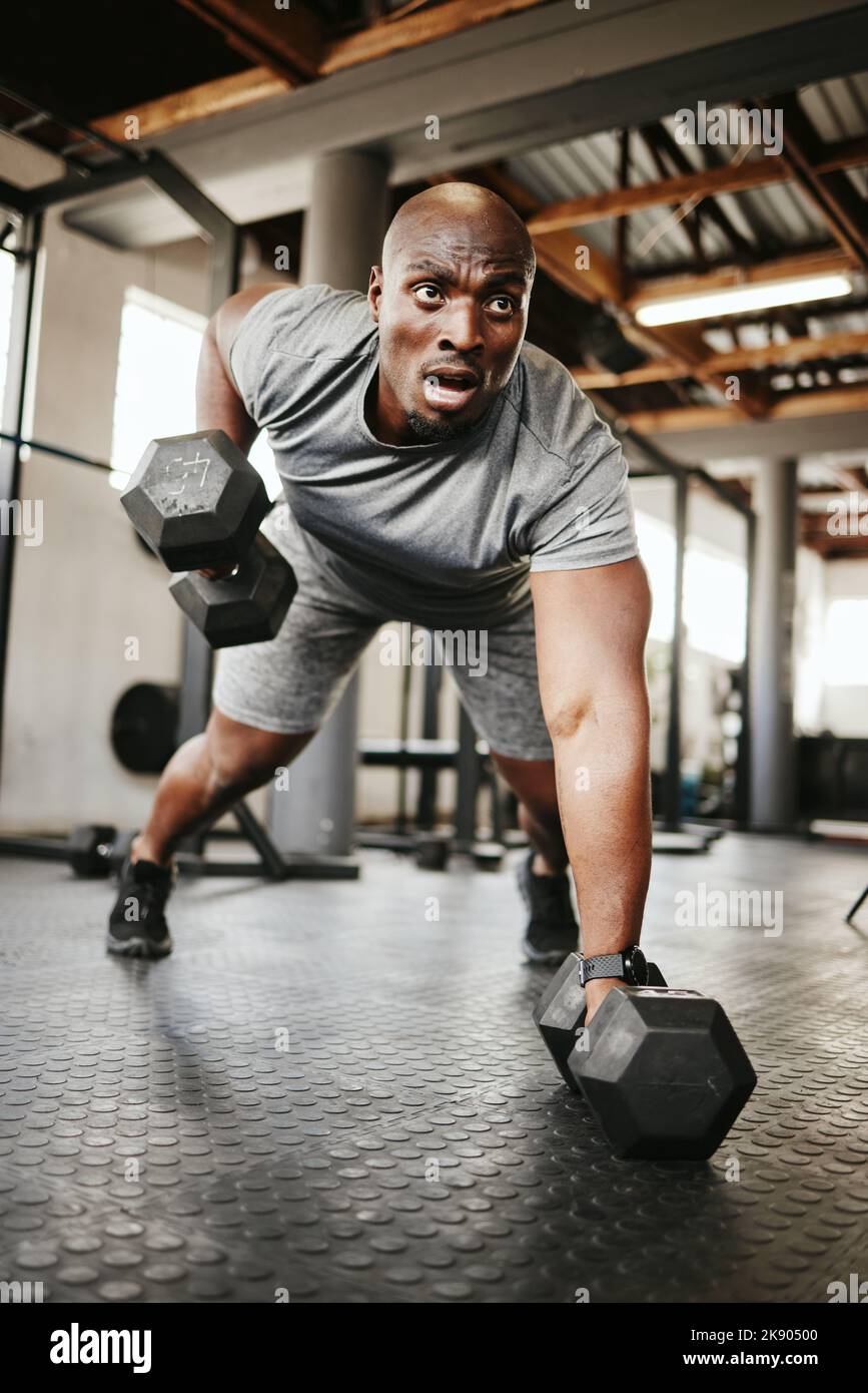 Fitness, gym and black man doing a workout with weights for strength ...