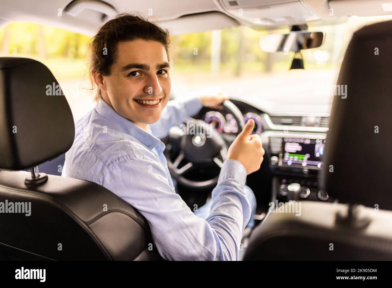 transport, vehicle and driving concept - man or car driver looking back ...