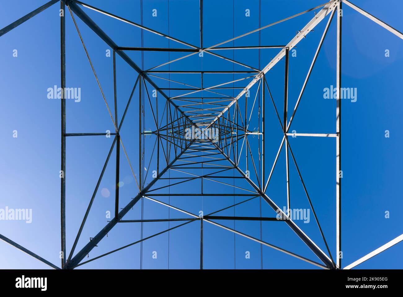 An abstract image looking straight up a transmission tower or pylon ...