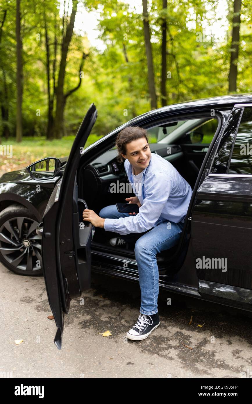 Businessman getting out of car hi-res stock photography and images - Alamy
