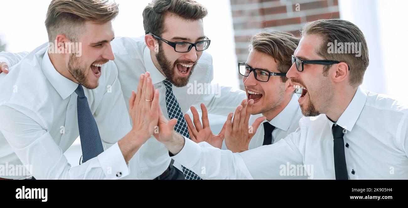 Happy excited business team, gives each other a high five Stock Photo ...