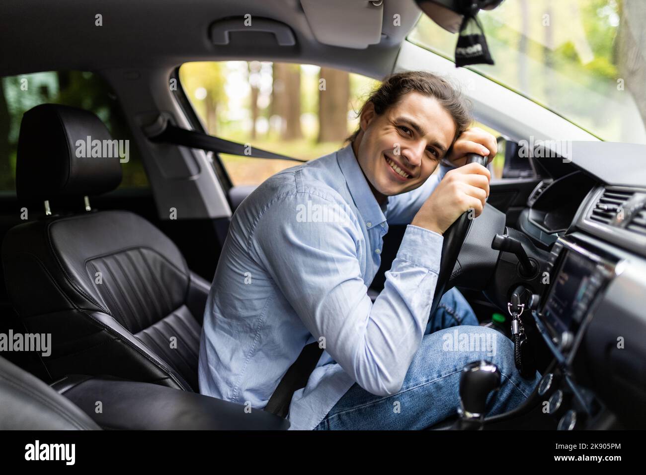 Tired young businessman rubbing eyes while driving car Stock Photo - Alamy