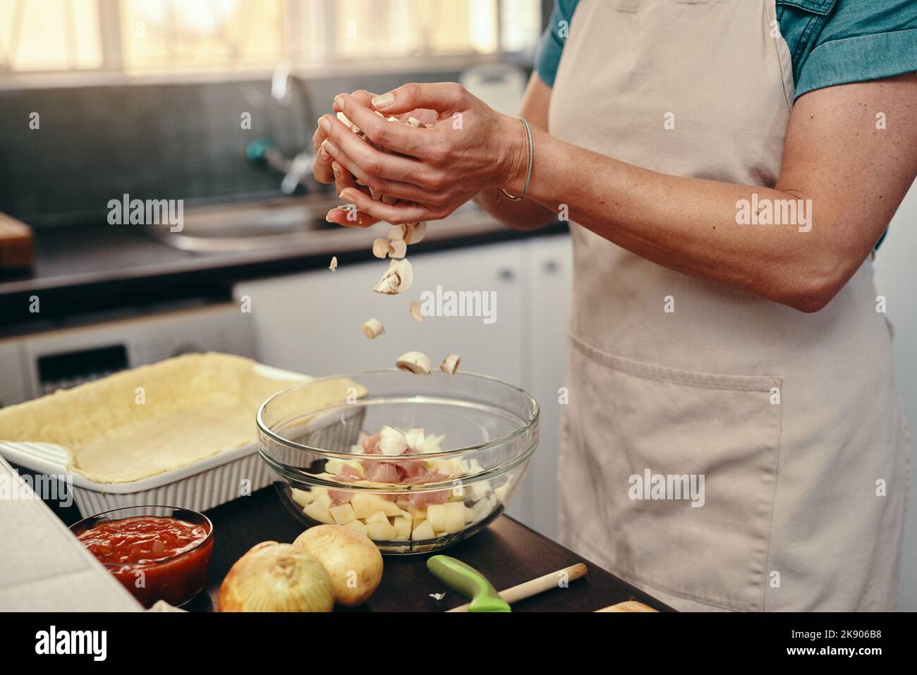 Pour it all in. an unrecognizable woman cooking and preparing a meal ...