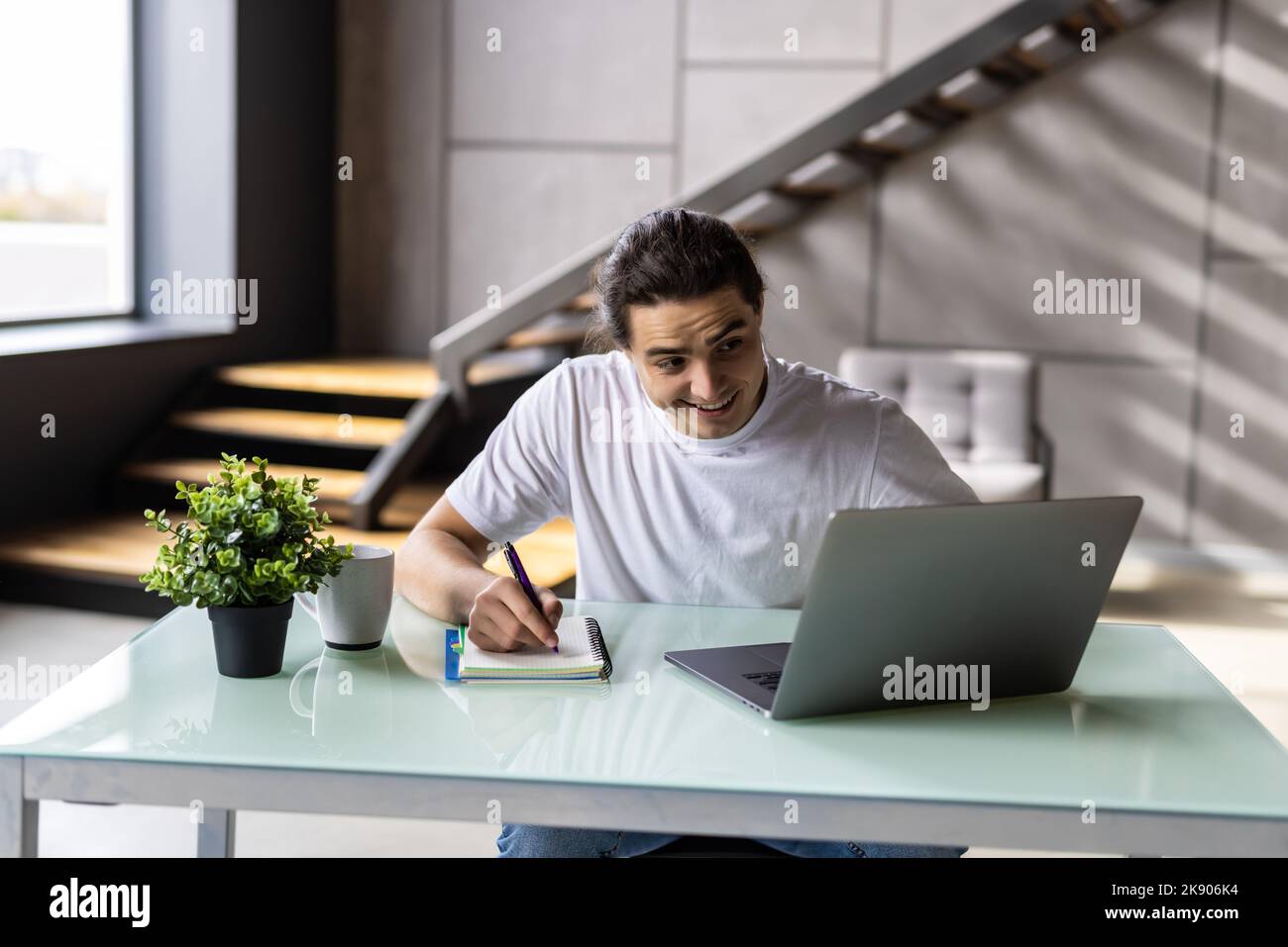 Successful entrepreneur smiling in satisfaction as he checks ...