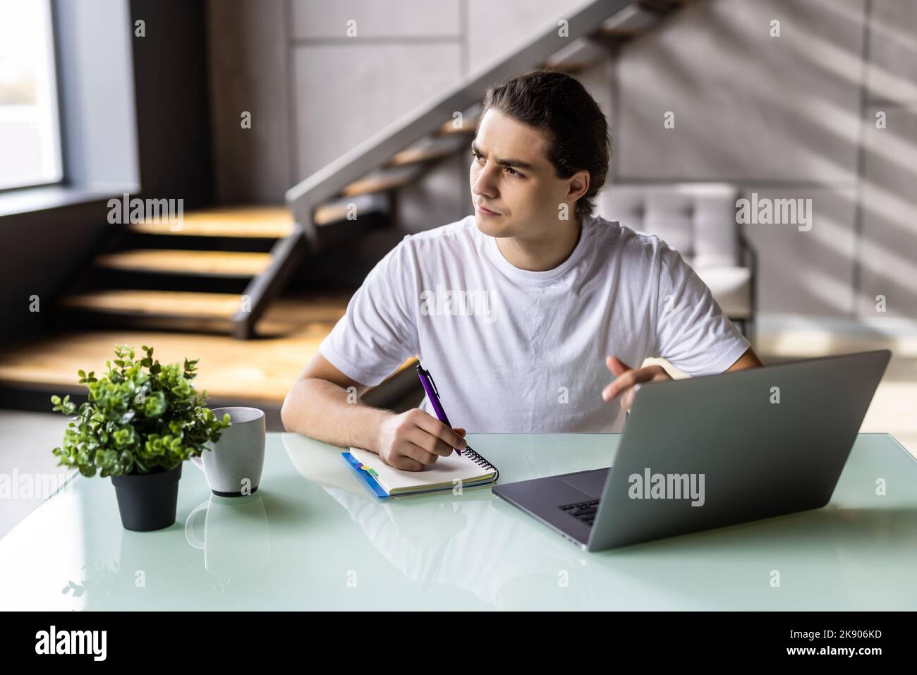 Portrait of a happy man taking notes Stock Photo - Alamy