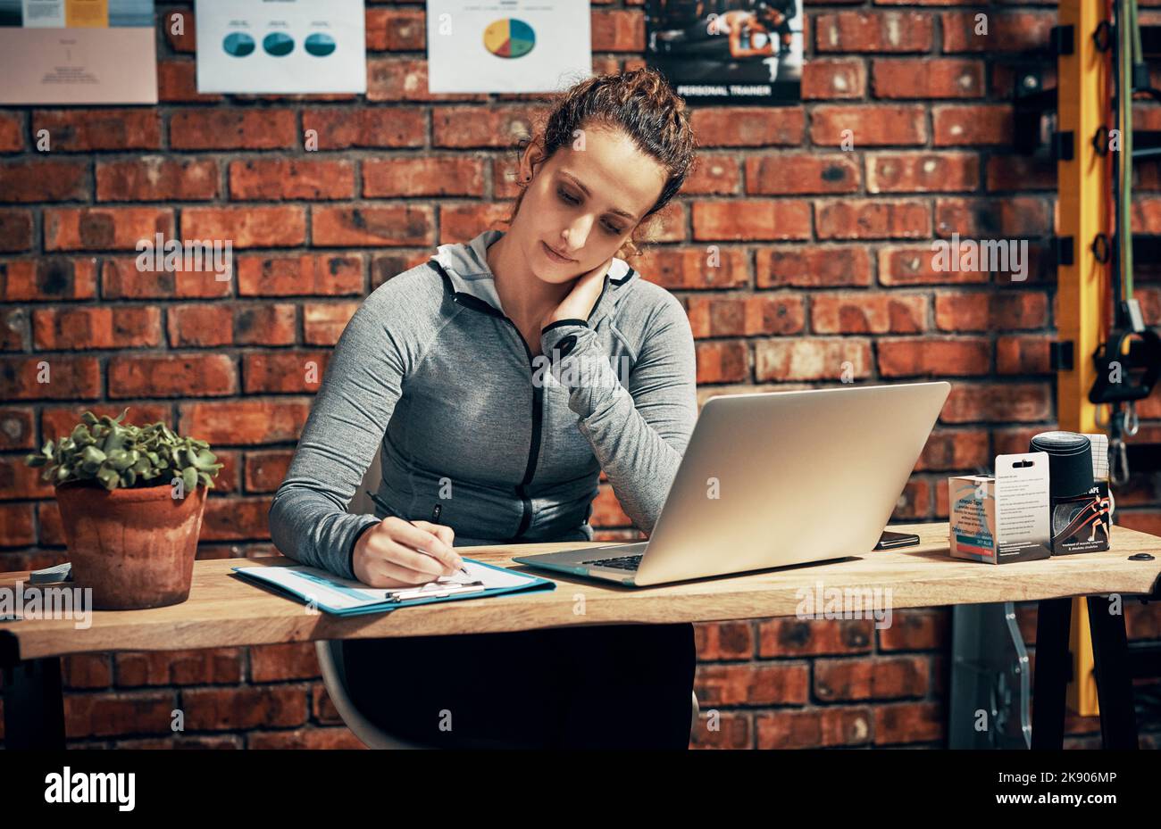 Setting up new workout routines. a fitness instructor making notes ...