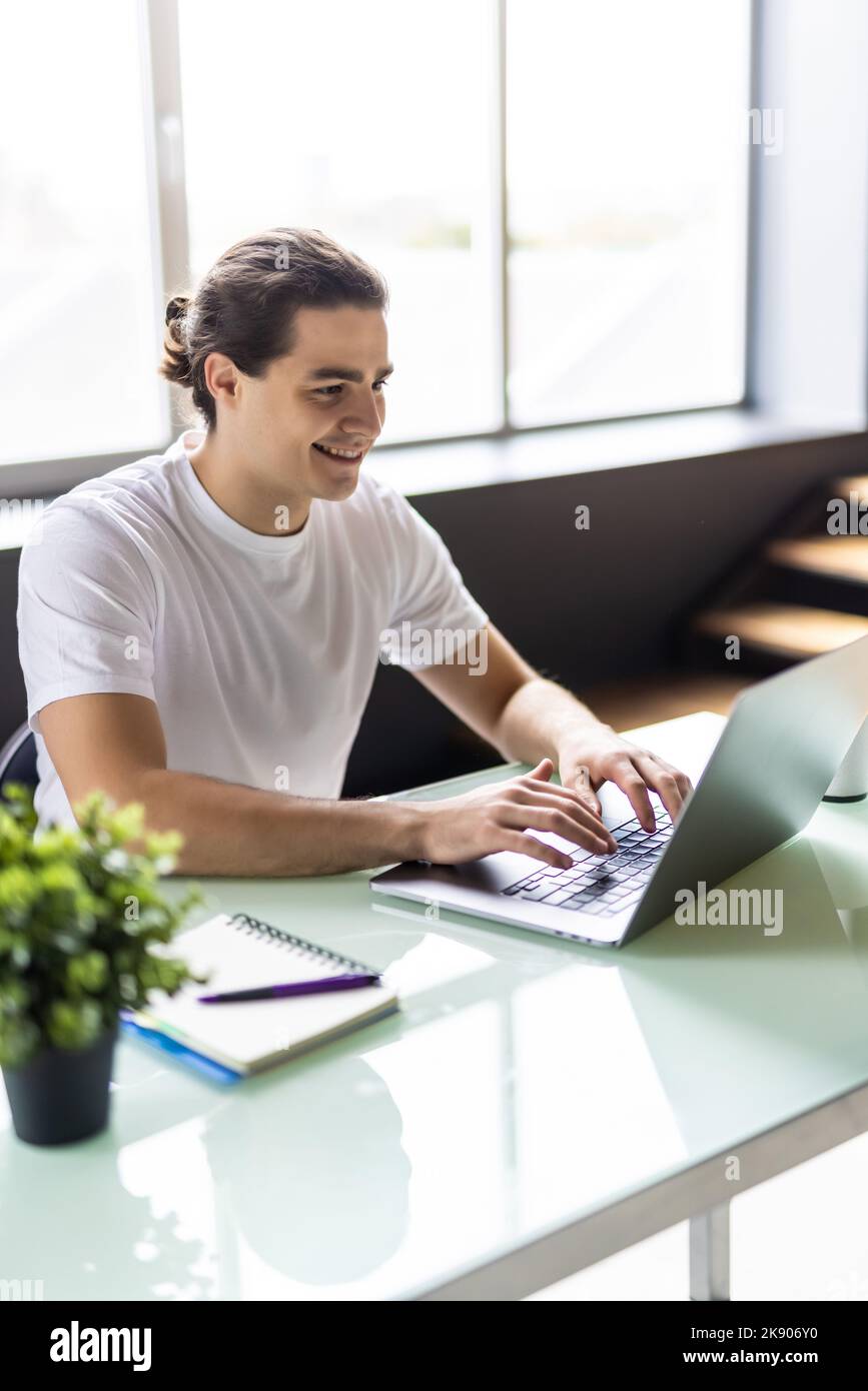 Successful entrepreneur smiling in satisfaction as he checks ...