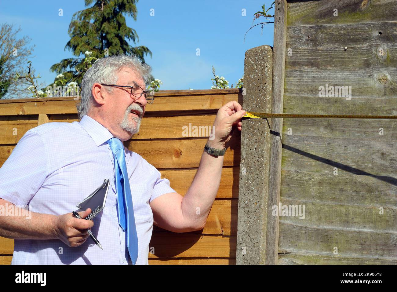Surveyor measuring property. Estate agent Stock Photo - Alamy