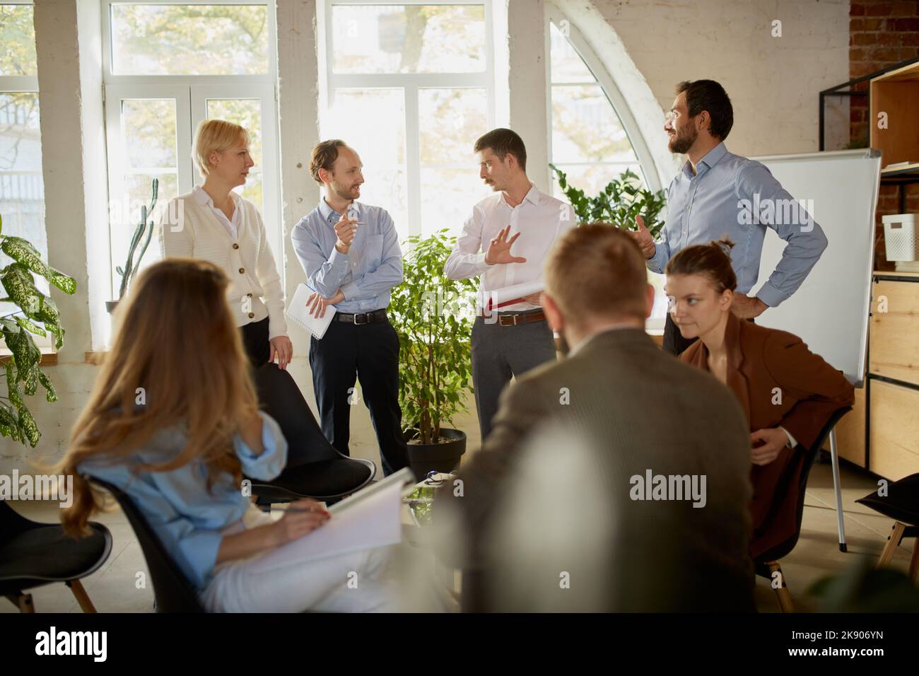 Young people talking, working, discussing problems and ideas with ...