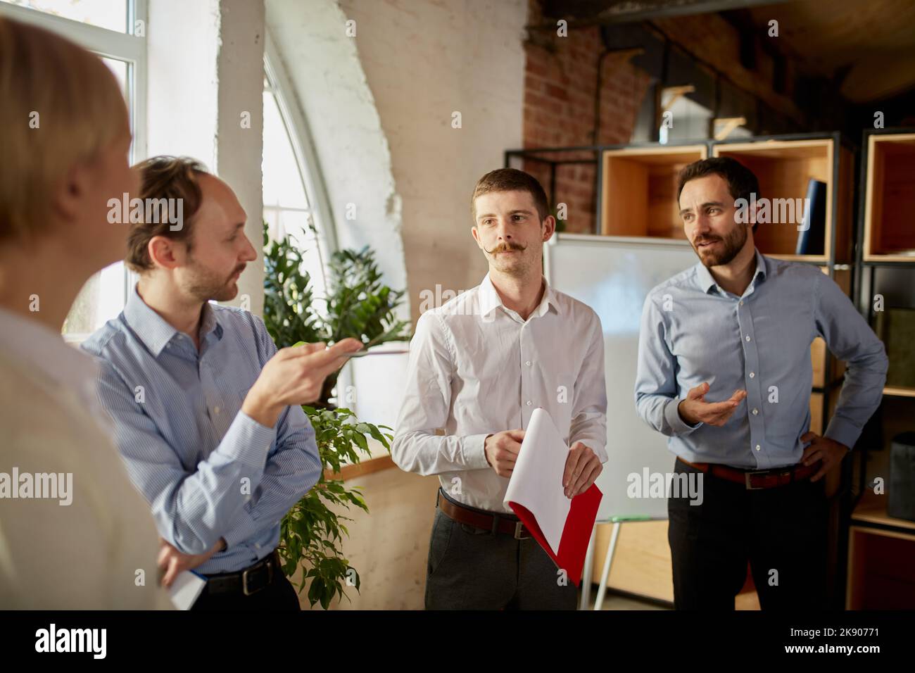 Young people talking, working, discussing problems and ideas with ...