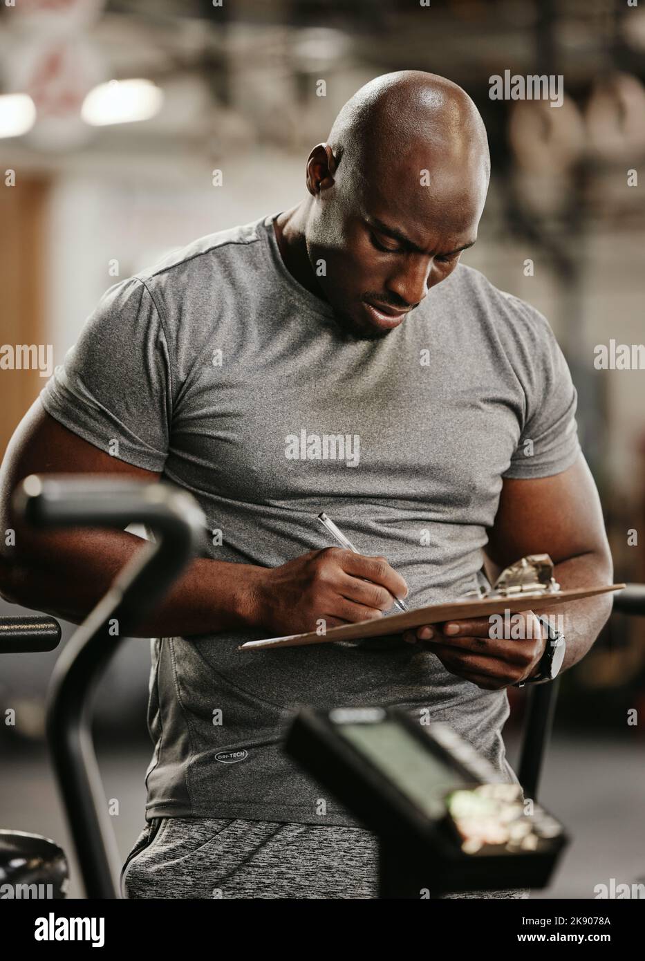 Fitness, clipboard and exercise with a personal trainer in the gym ...