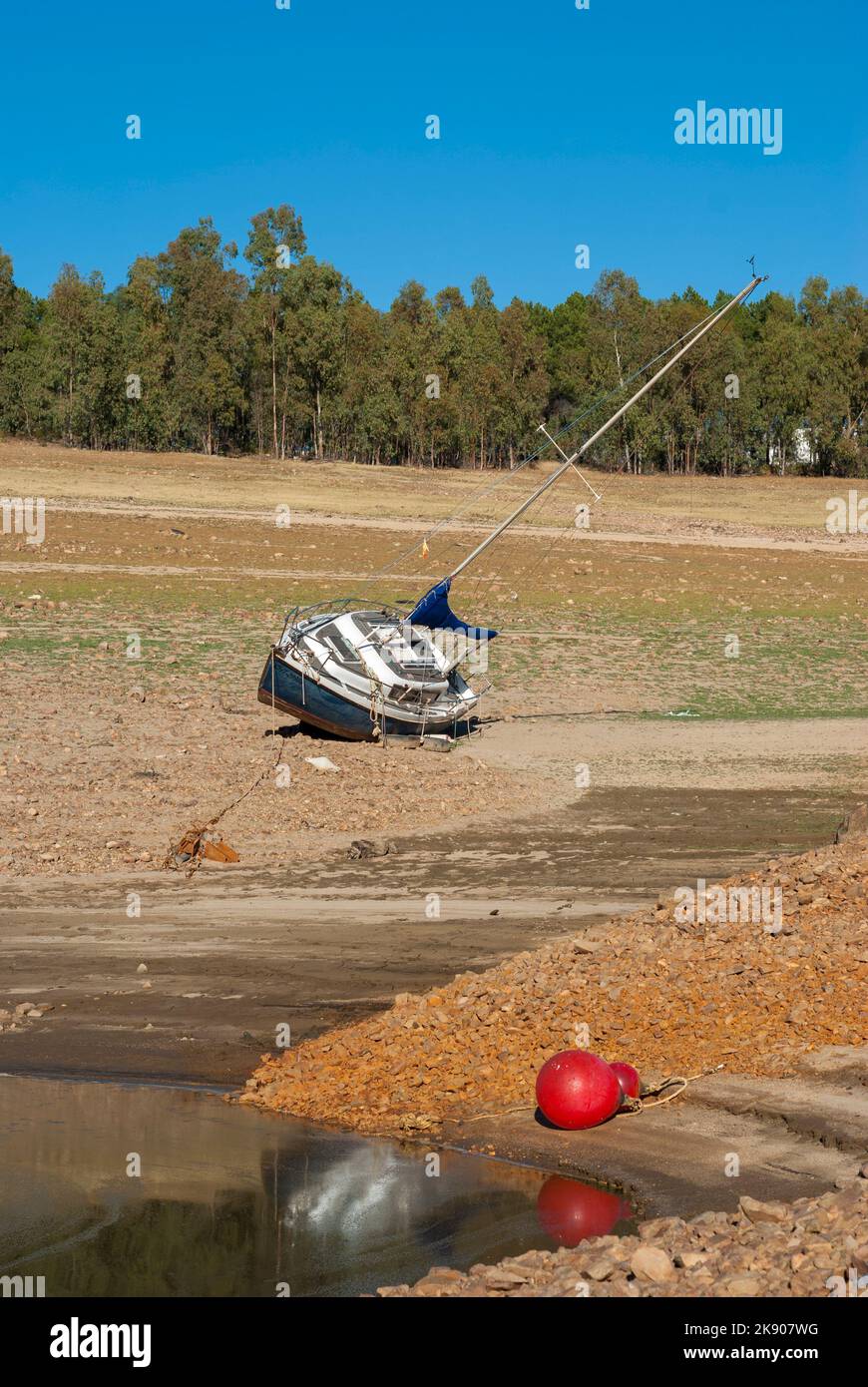 sailboat stranded on land due to drought with blue sky trees in the ...