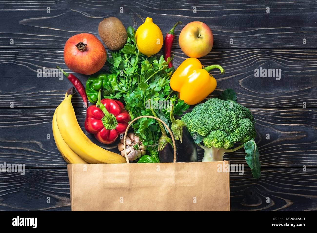 Eco friendly paper shop bag with raw organic green vegetables isolated ...