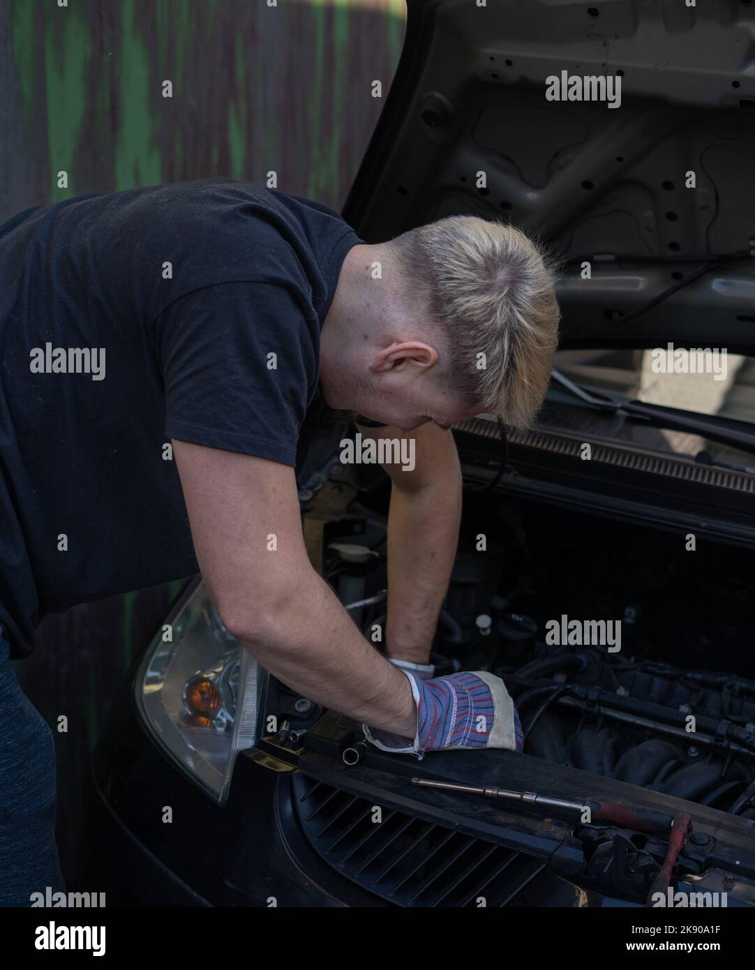 The mechanic repairs the car under the hood Stock Photo - Alamy