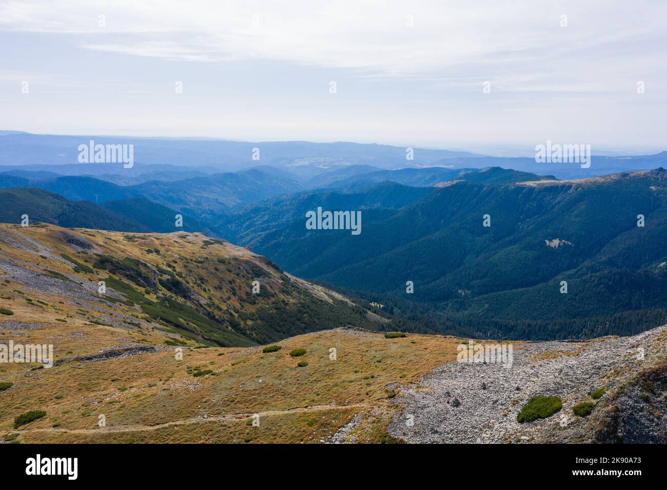 Stunning view of blue cloudy sky over layered mountain ranges and ...