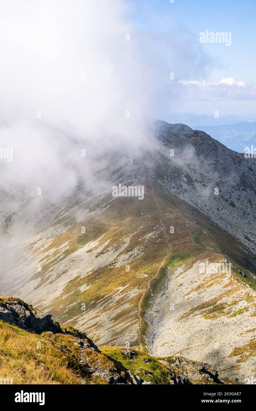 Stunning view of white clouds and blue sky over layered mountain ranges ...