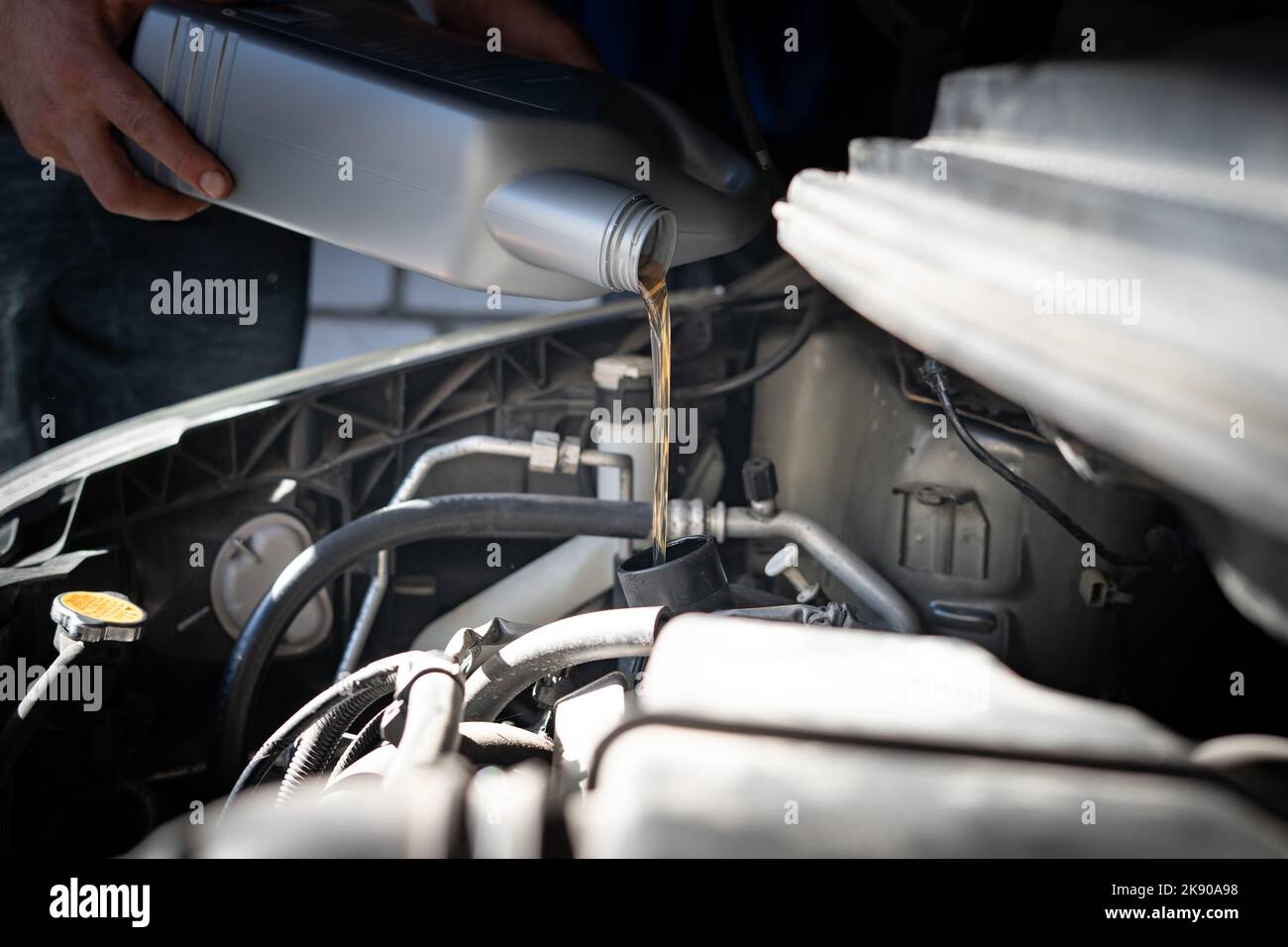 Engine oil is pouring into the engine Stock Photo - Alamy