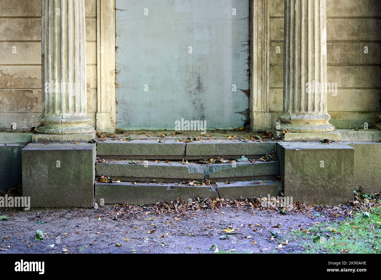 A closeup of an old broken stone staircase of a tomb in a cemetery ...