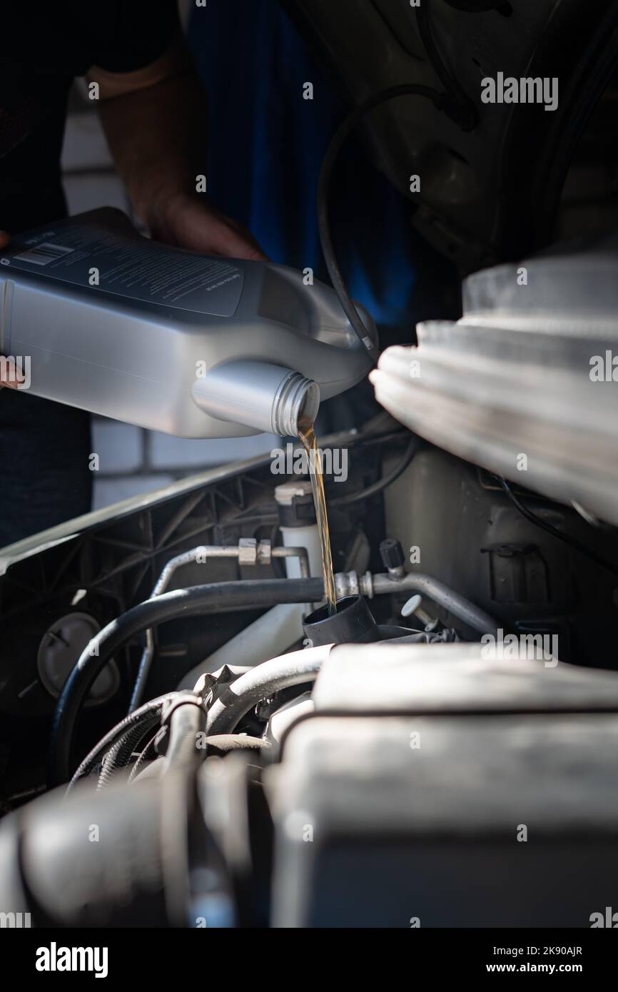 Engine oil is pouring into the engine Stock Photo - Alamy