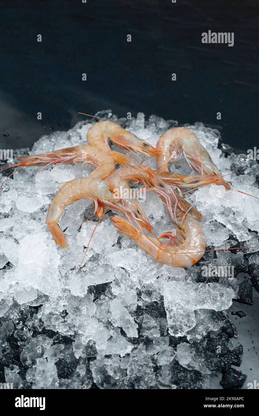 A vertical shot of raw fresh shrimps on ice displayed in a market Stock ...