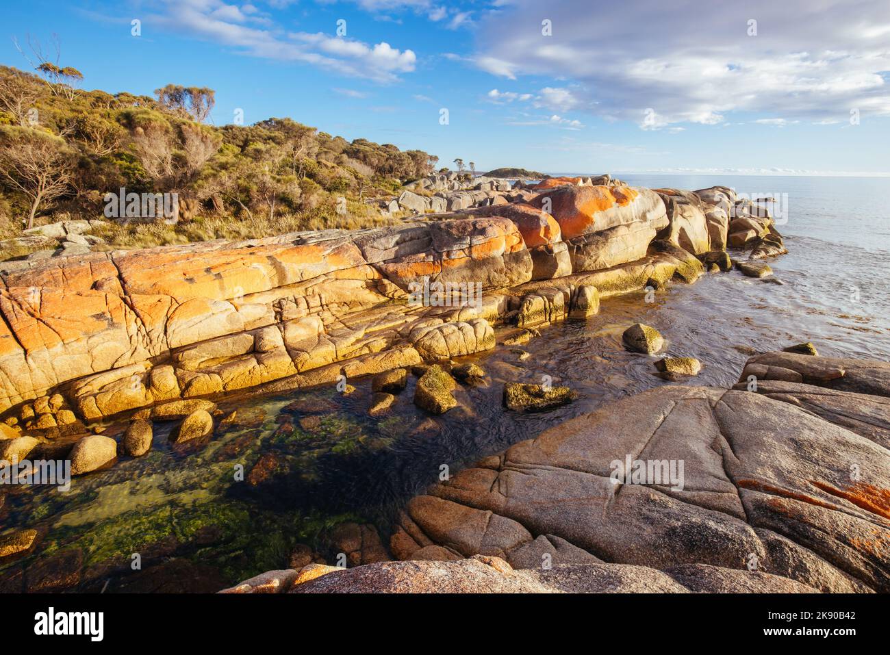 The iconic lichen covered rocks and turqoise ocean water in the Bay of ...