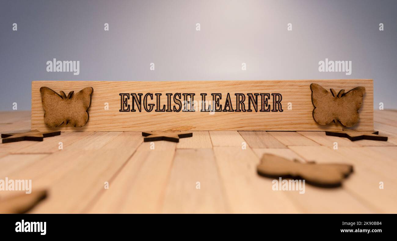 English Learner was written on the wooden surface. Wooden butterflies ...