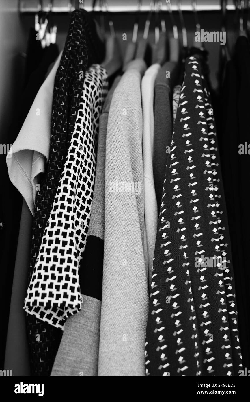 A vertical grayscale closeup of the clothes in a wardrobe Stock Photo ...