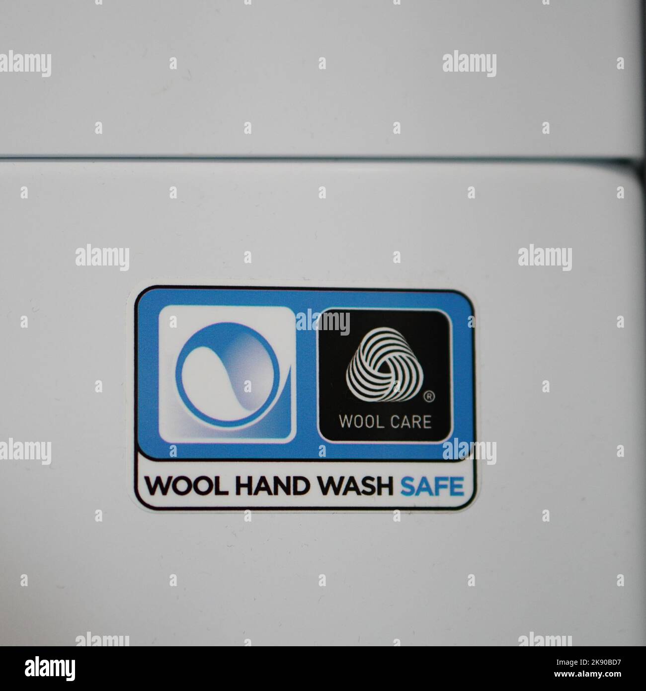 A vertical closeup of a Wool Hand Wash Safe sticker on a laundry ...