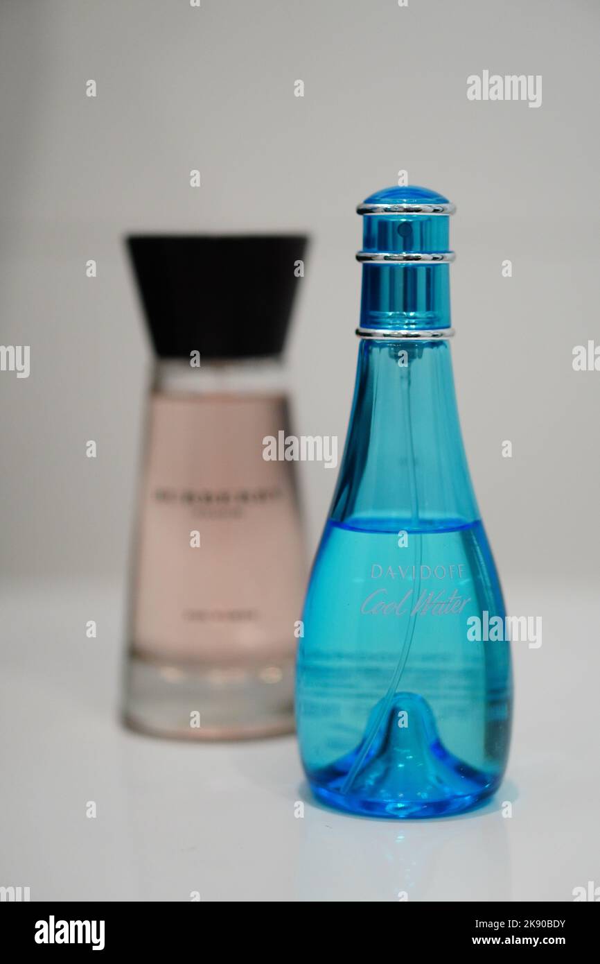 A vertical closeup of Davidoff women's perfume in a blue spray bottle ...