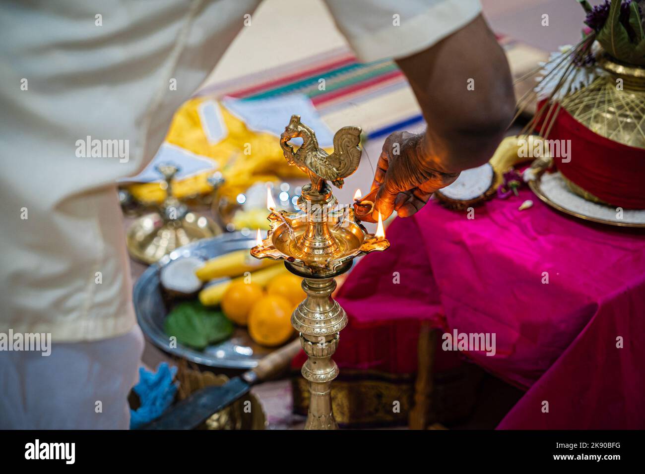 A tea light is lit up during the puja ceremony on the night of Diwali ...