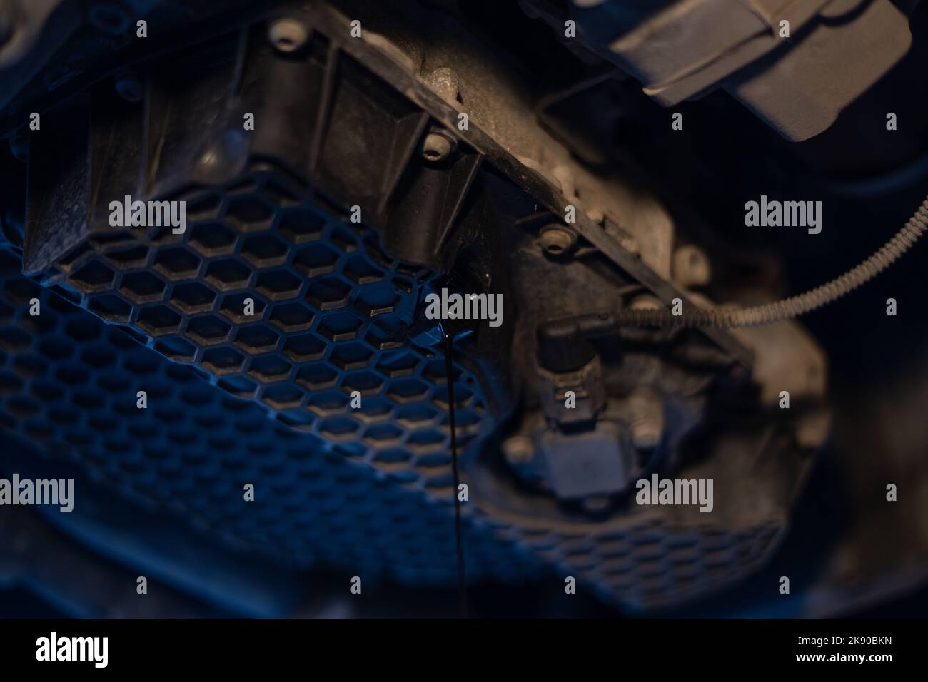 Engine oil flows out of the hole Stock Photo - Alamy