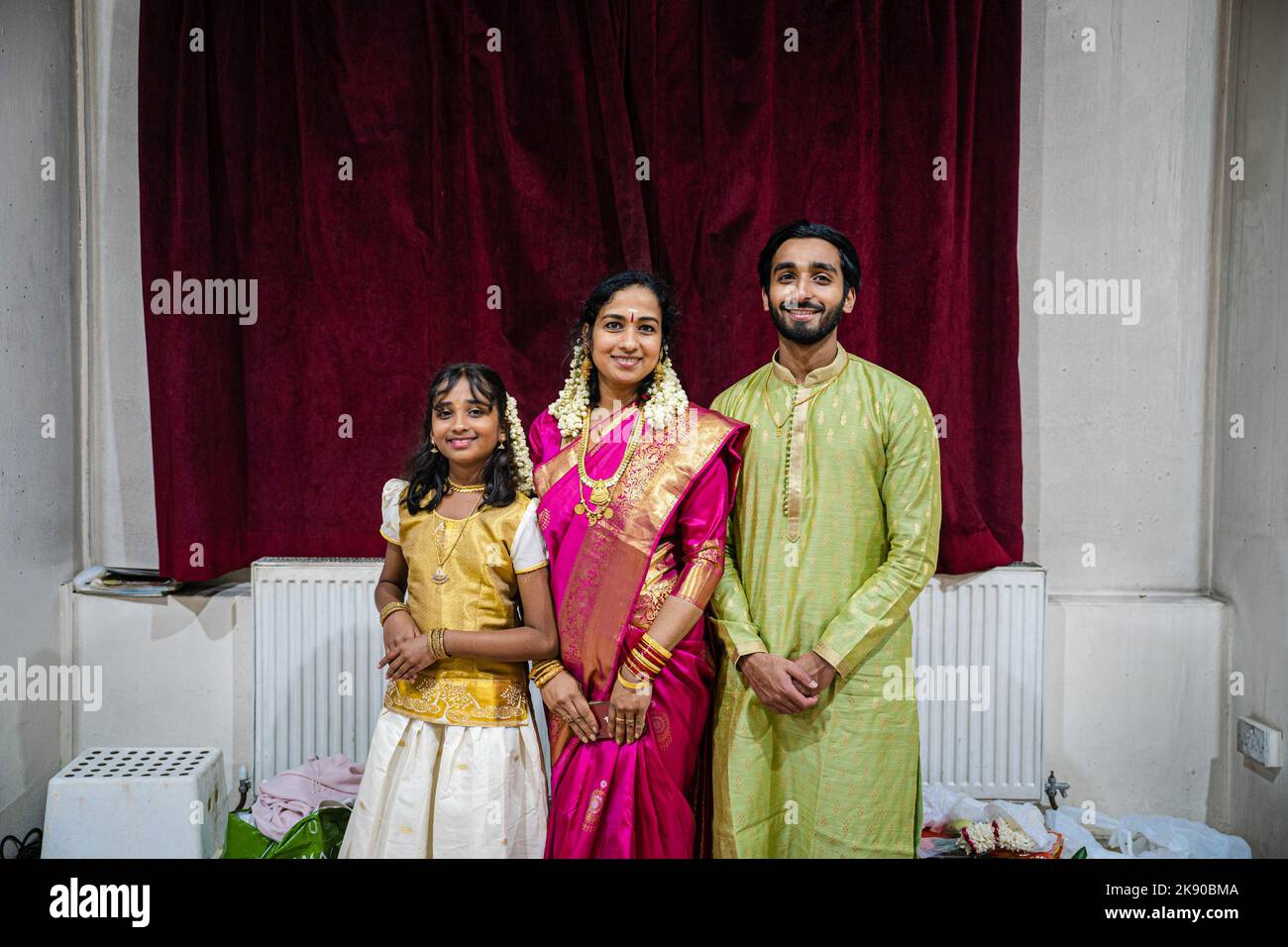 A family donned in new clothing arrives at the temple on the night of ...