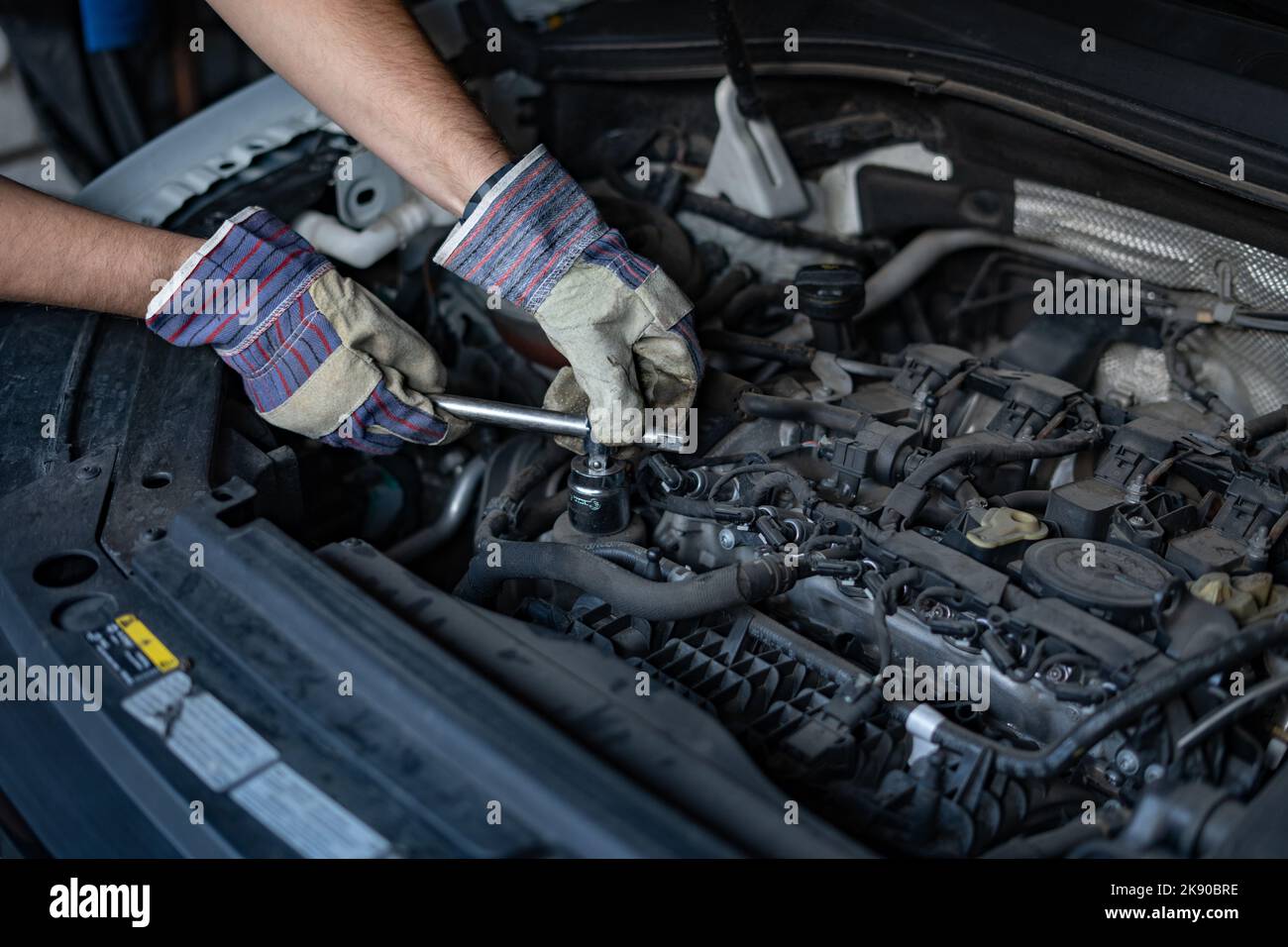 The mechanic repairs the car under the hood Stock Photo - Alamy