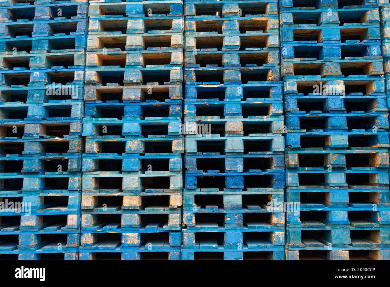 Stacks of wooden palettes painted blue Stock Photo - Alamy