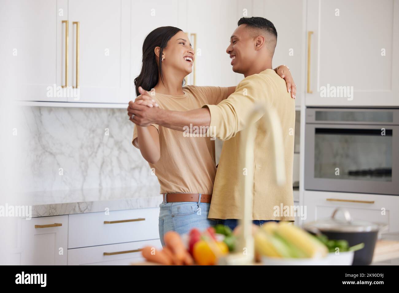 Couple, love and dancing together in kitchen happy at home bonding ...
