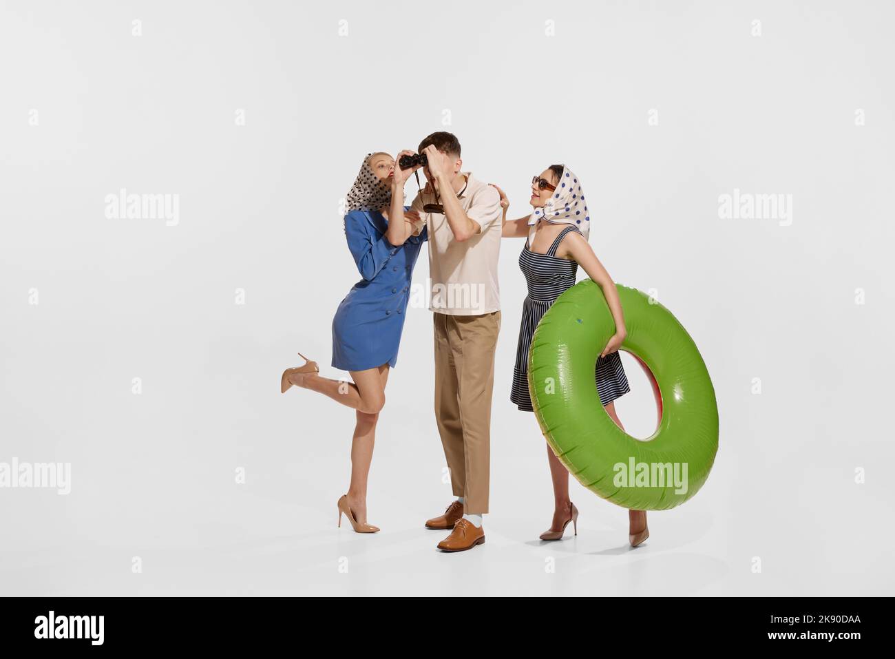 Portrait of three young people travelling together, taking photos ...