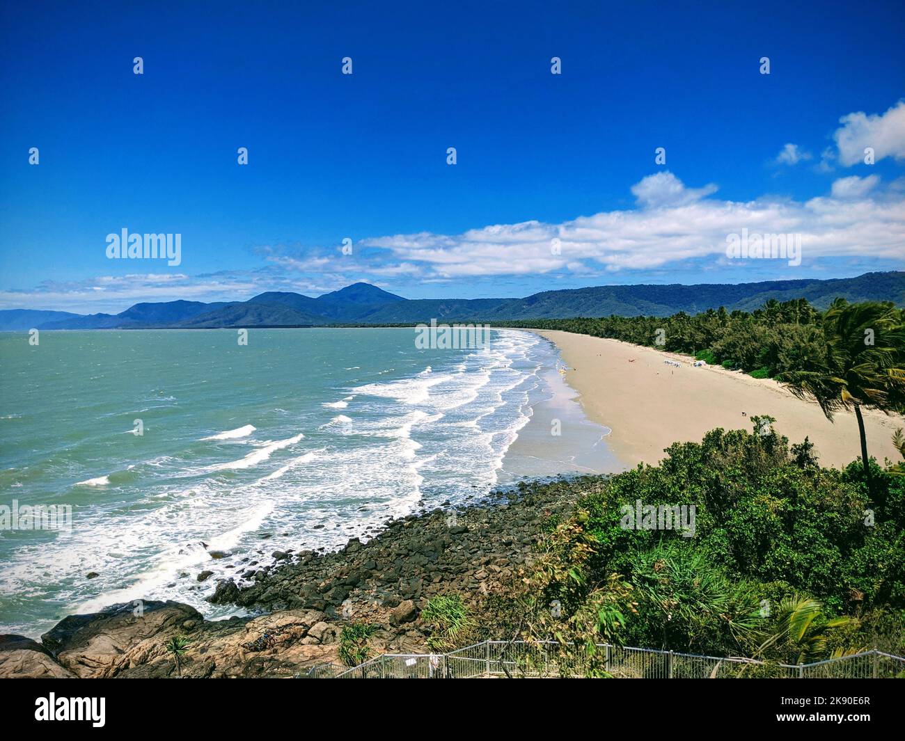 The beautiful view of the sandy beach with green vegetation and sea ...
