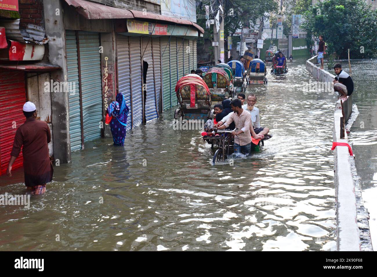 Rickshaws try driving with passengers through the flooded street of Dhaka last night heavy ...