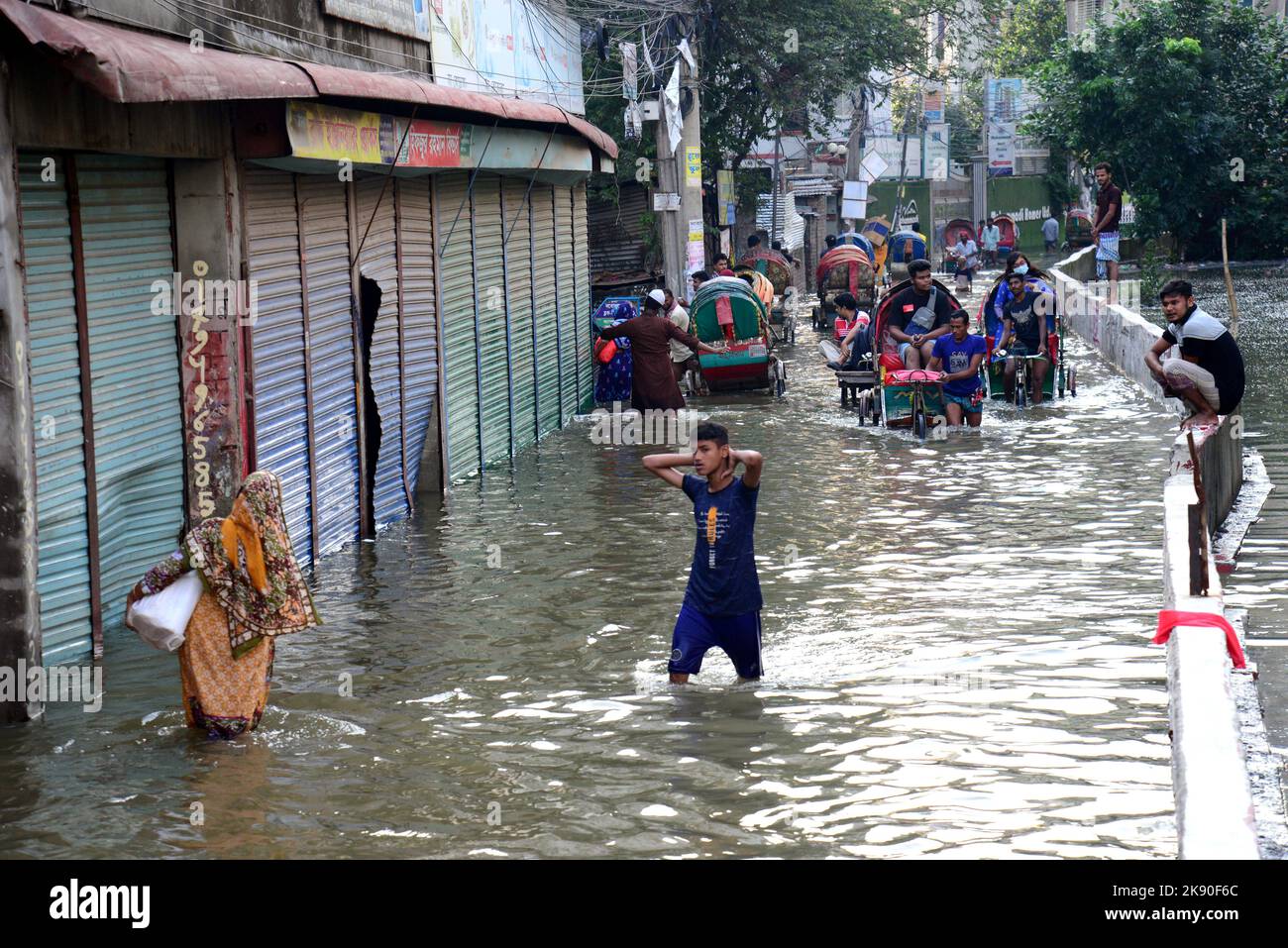 Rickshaws try driving with passengers through the flooded street of ...