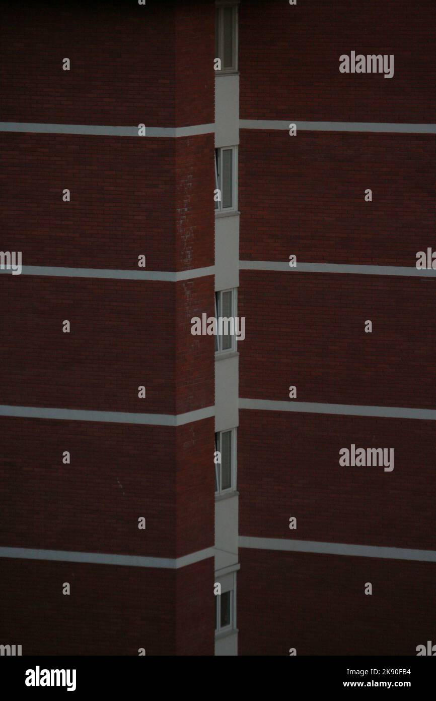 A vertical high-angle of brown and white cladding brick apartment ...