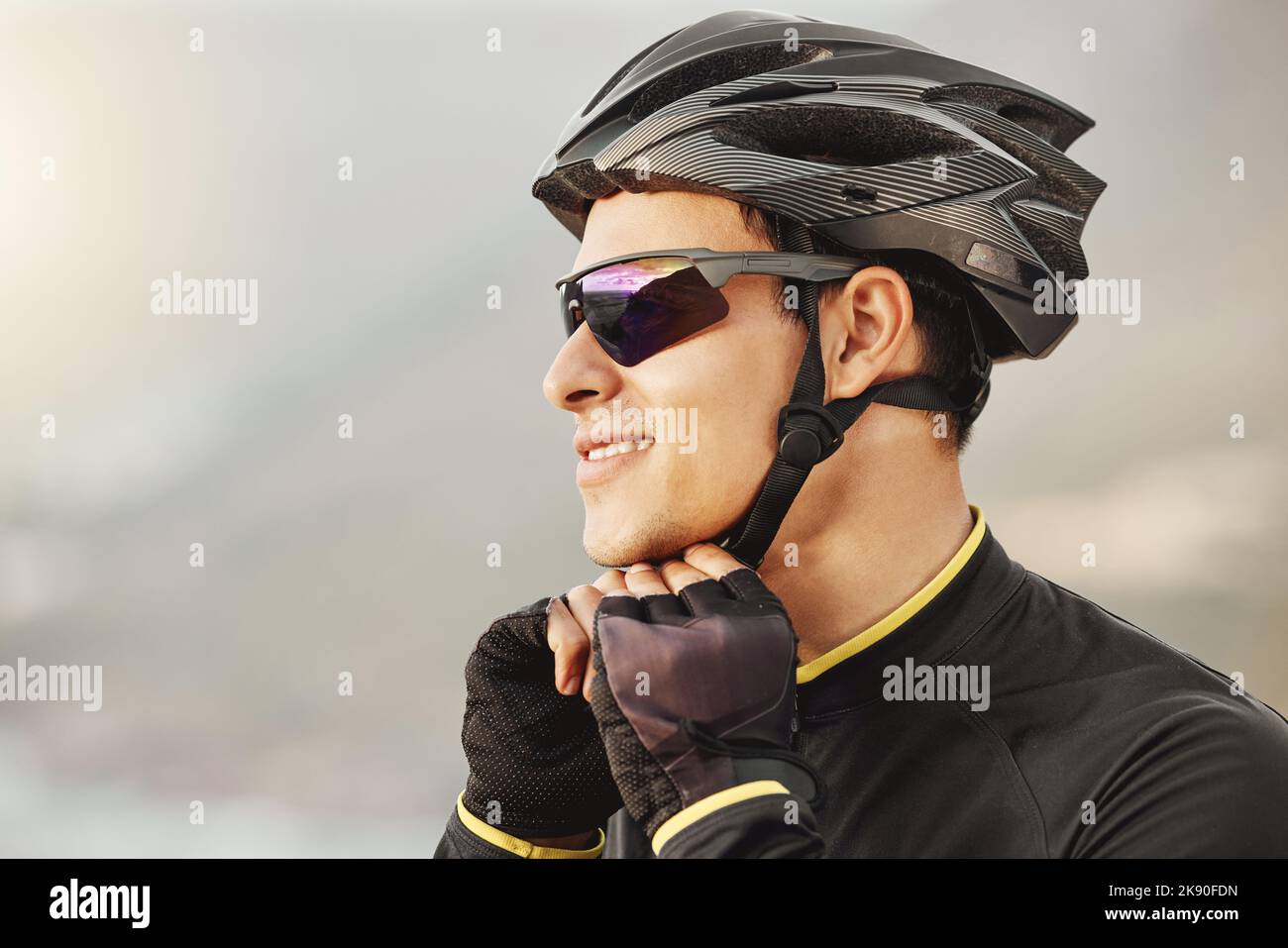 Fitness, sports and cyclist checking his helmet before cycling ...