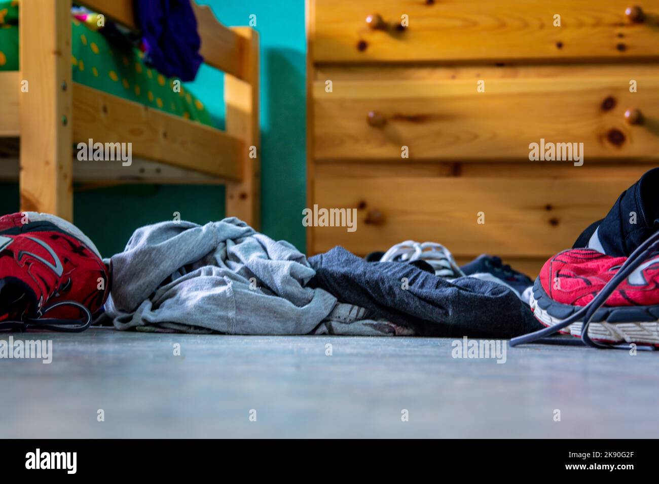 Some clothes thrown at the ground of a messy room Stock Photo - Alamy