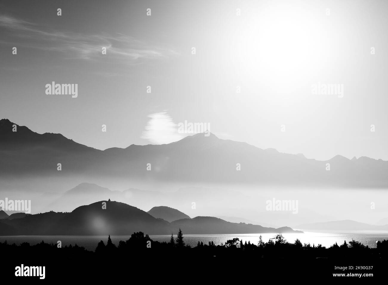 A grayscale shot of the silhouettes of mountains Stock Photo - Alamy