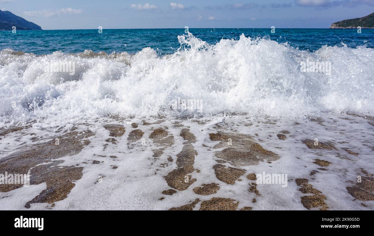 a beautiful scenery of foam waves of the sea on the beach - great for ...